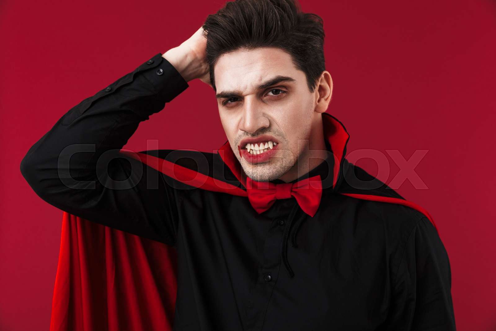 Image of handsome vampire man with fangs in black halloween costume ...