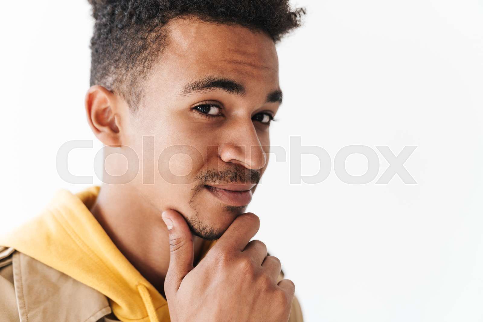 Image of brooding african american guy touching his chin in studio ...