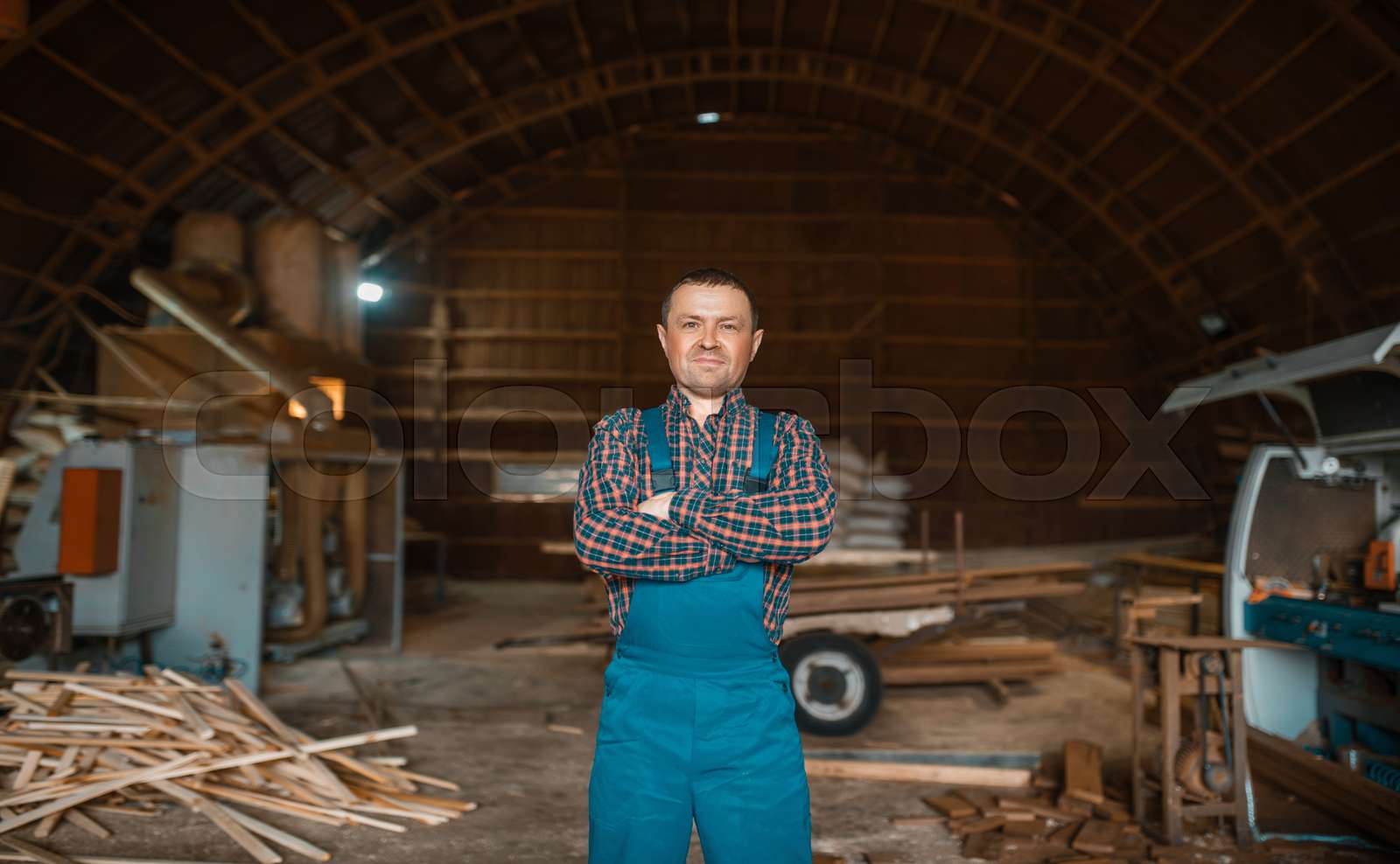 Woodworker in uniform at his workplace, lumbermill | Stock image ...