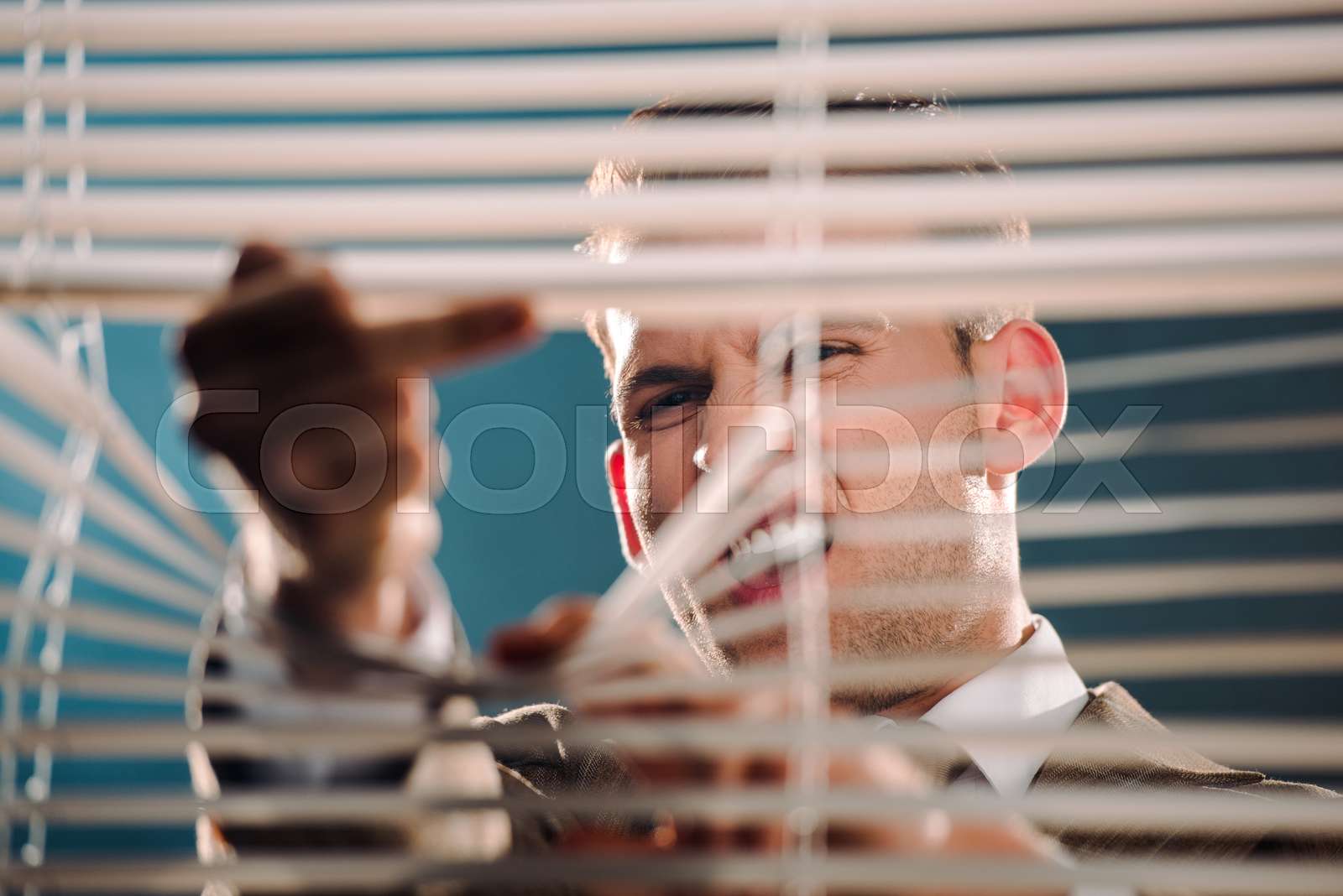 selective focus of emotional gangster showing middle finger through ...