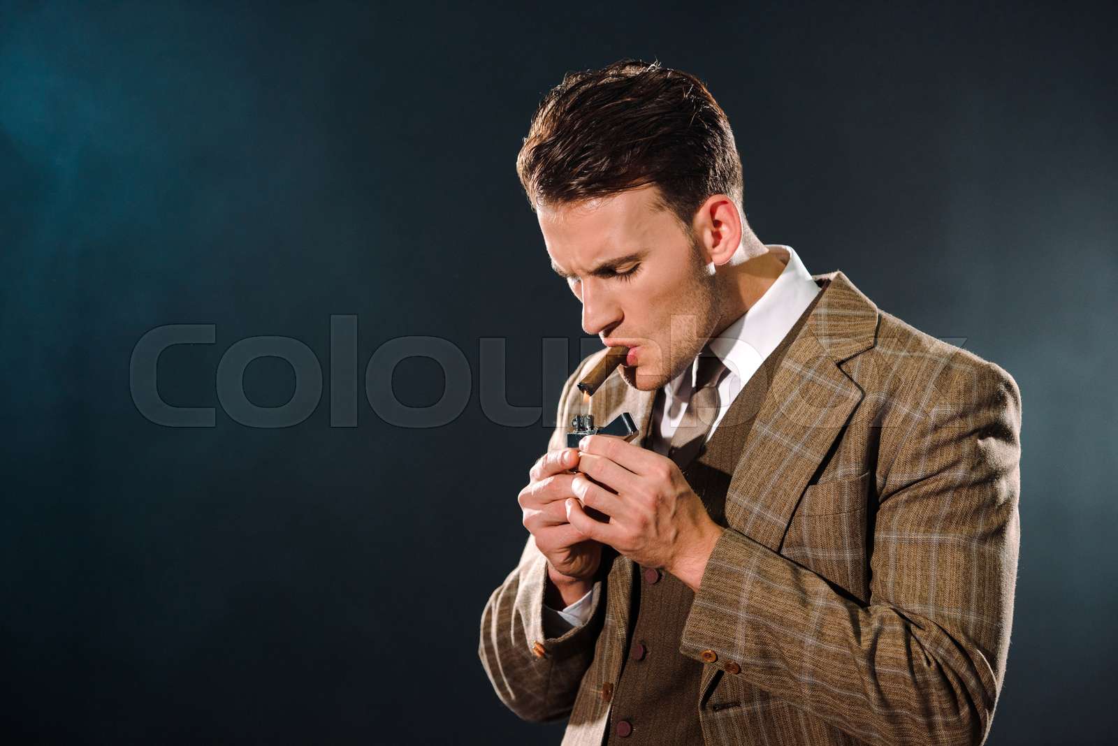 handsome gangster smoking cigar on black | Stock image | Colourbox