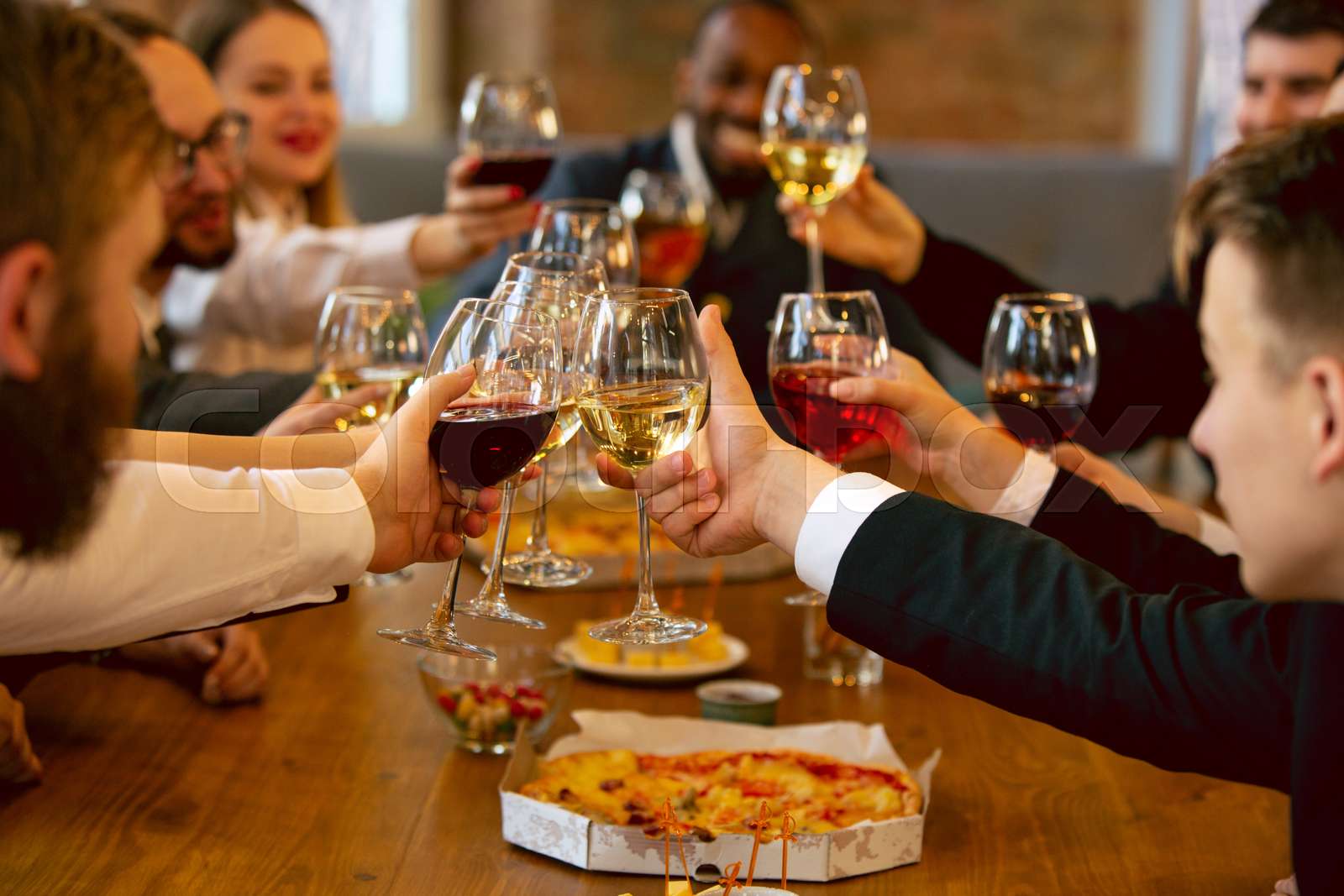 Happy co-workers celebrating while company party and corporate event ...