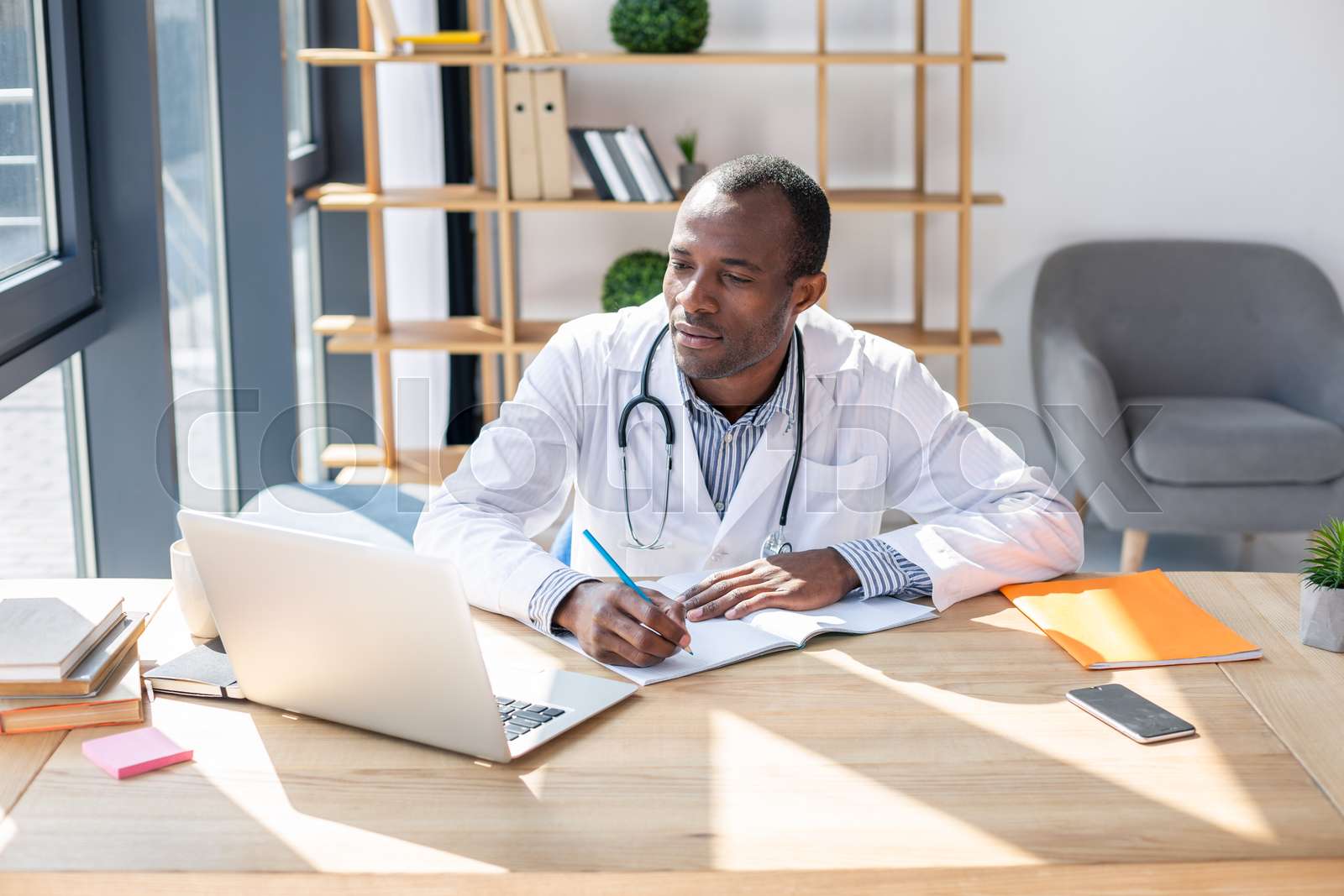 Attentive international male person completing task | Stock image ...