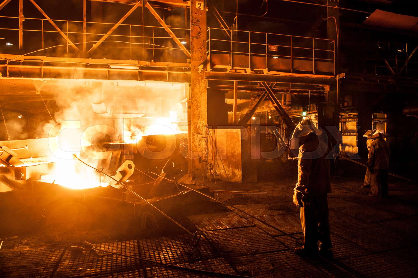 Steelworkers when pouring liquid titanium slag from arc furnace | Stock ...