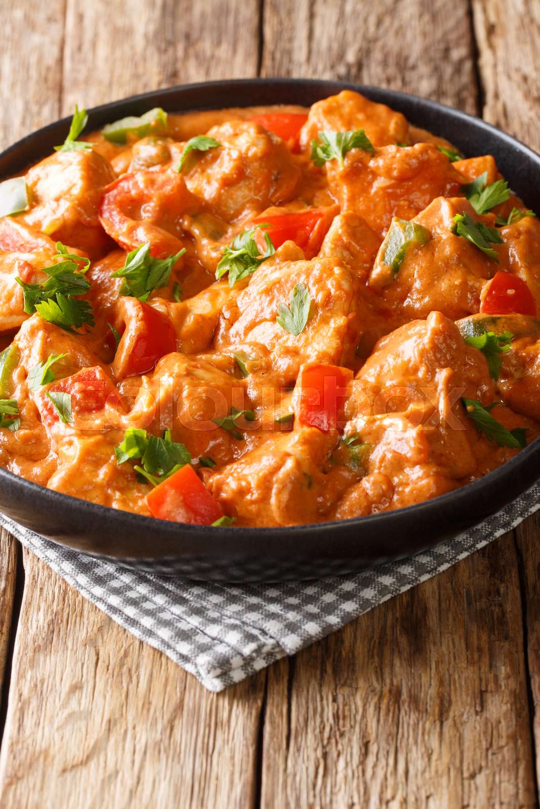 Popular spicy chicken mafe in thick peanut sauce close-up in a plate ...