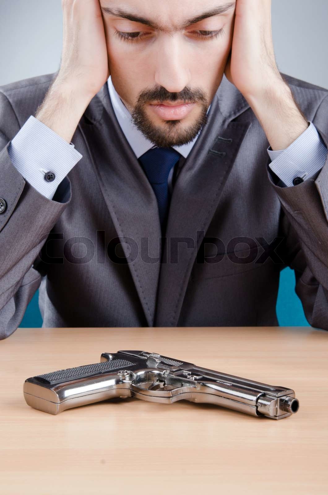 Businessman man with hand gun | Stock image | Colourbox