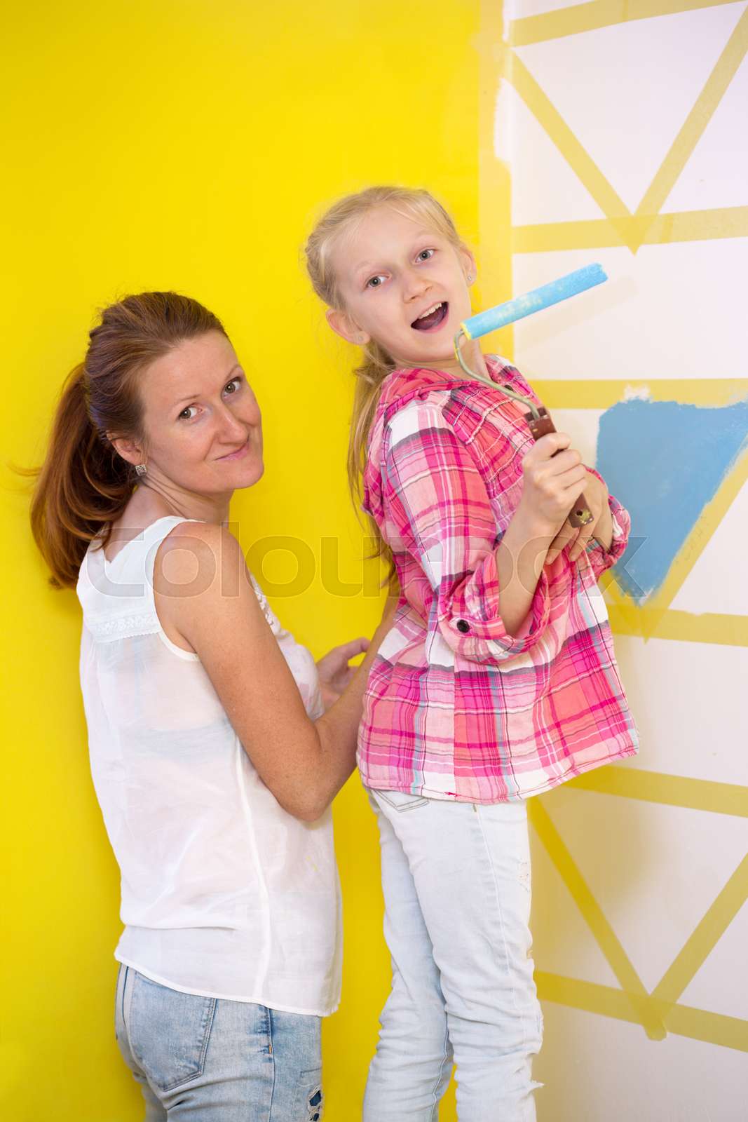 mom and daughter paints the wall | Stock image | Colourbox