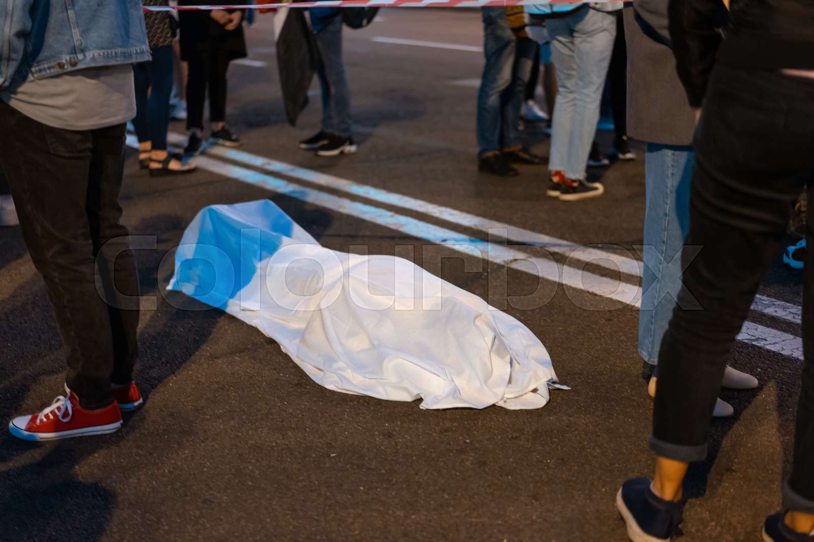Human body covered by a sheet lying on the street. | Stock image ...