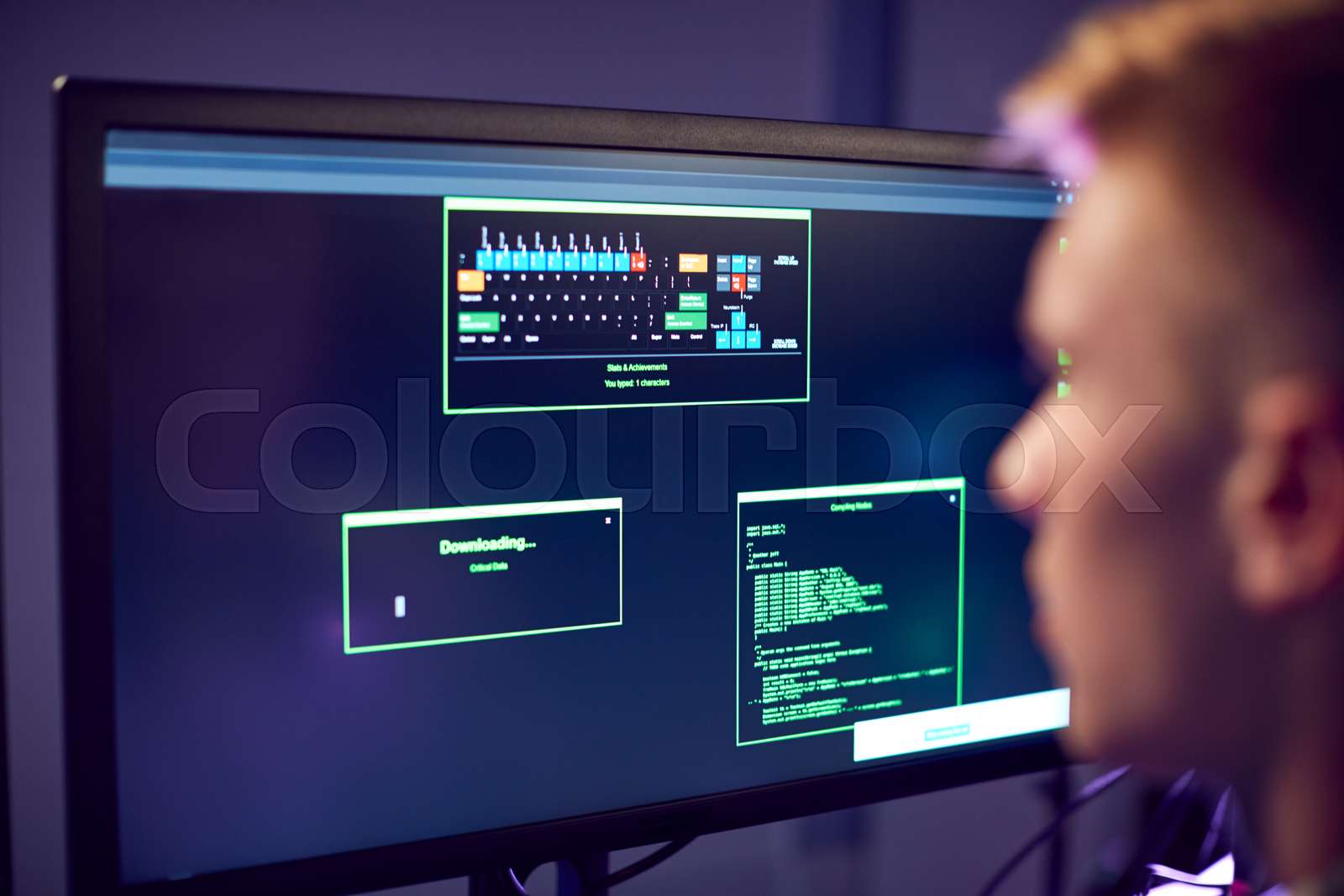 Male Teenage Hacker Sitting In Front Of Computer Screens Bypassing ...