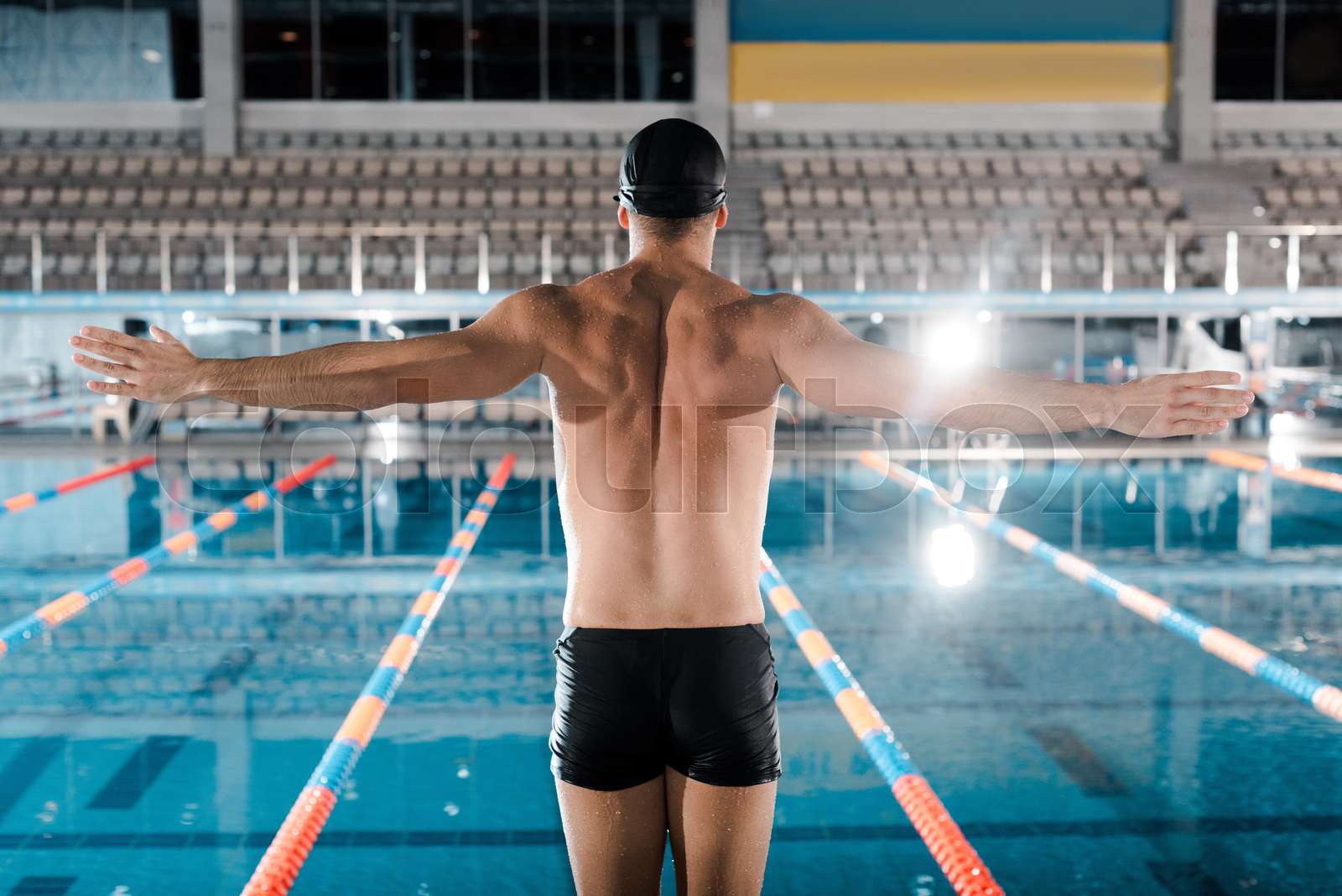 back view of swimmer standing with outstretched hands | Stock image ...
