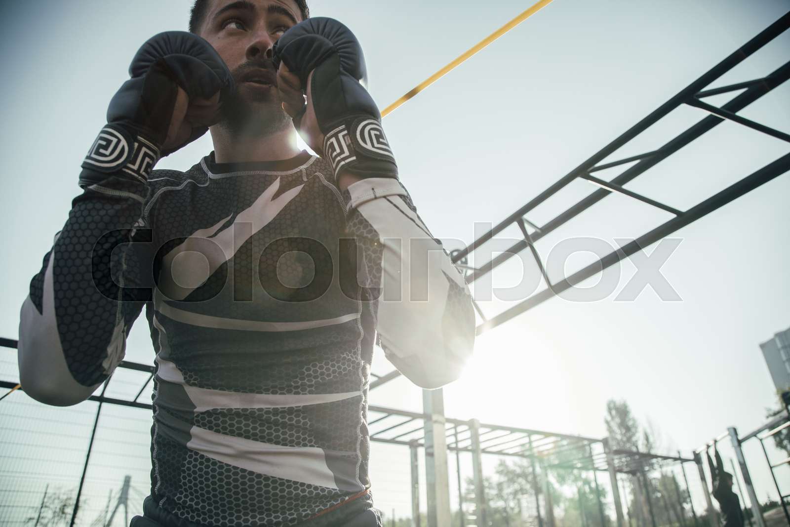 Portrait of the serious confident boxer looking into the distance ...