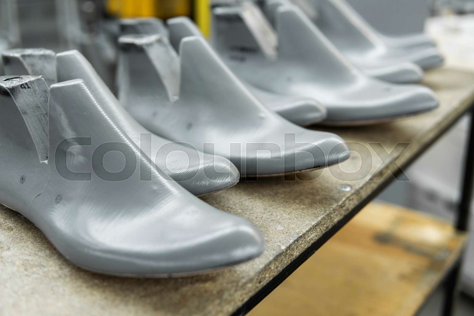 Plastic lasts used in the manufacture of shoes. Row of plastic shoe lasts used to manufacture ...