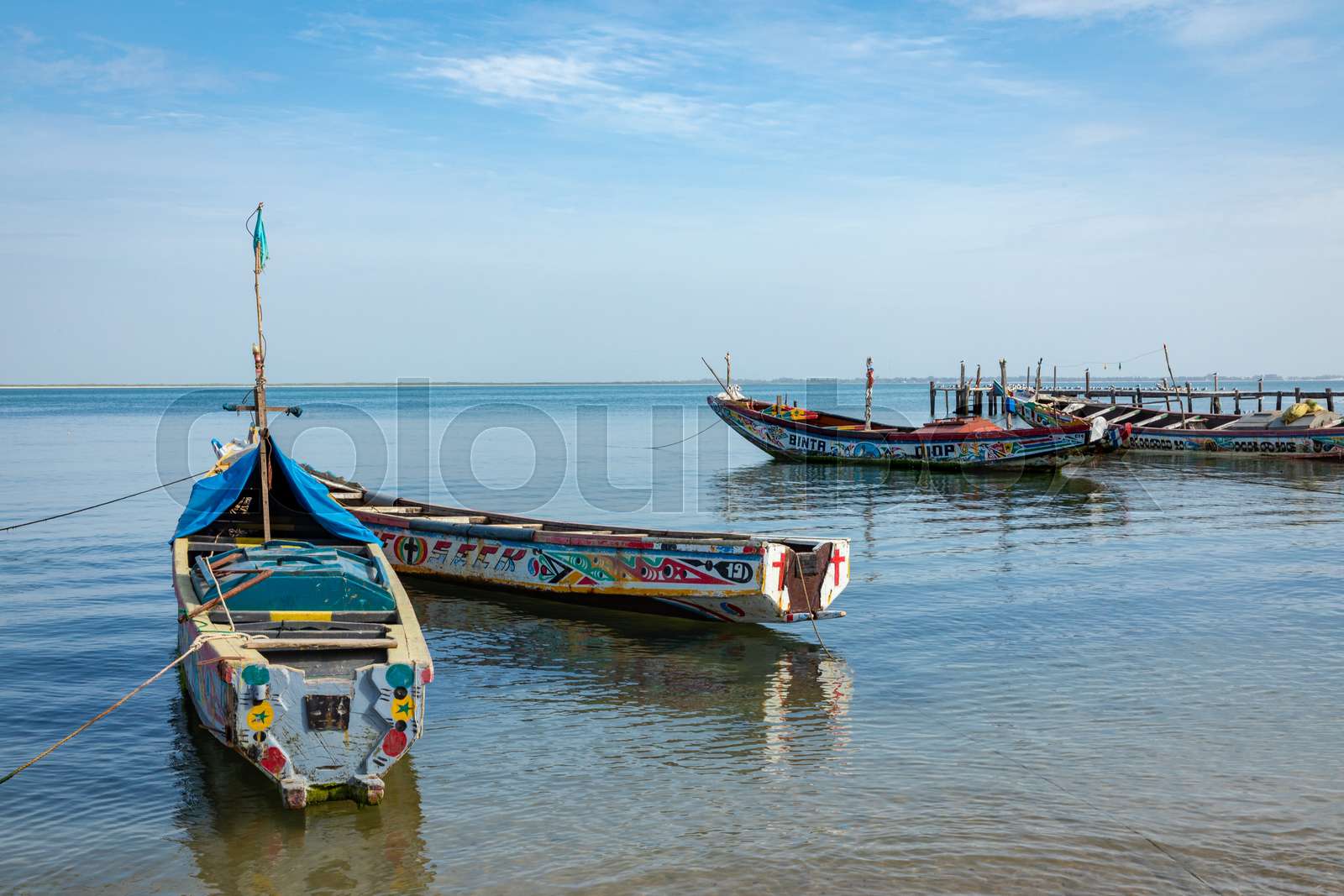 Traditional painted wooden fishing boat in Djiffer, Senegal. West ...