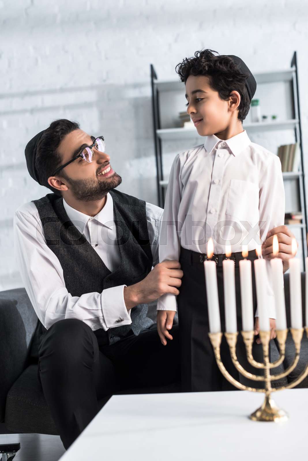 smiling jewish father looking at cute son in apartment | Stock image ...
