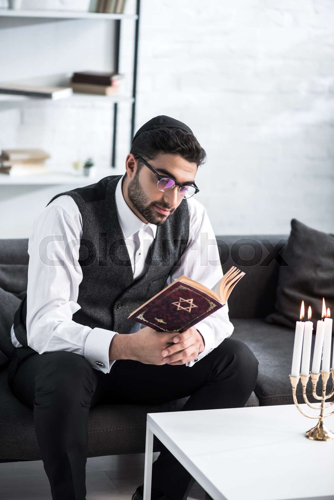 handsome jewish man in glasses reading tanakh in apartment | Stock ...