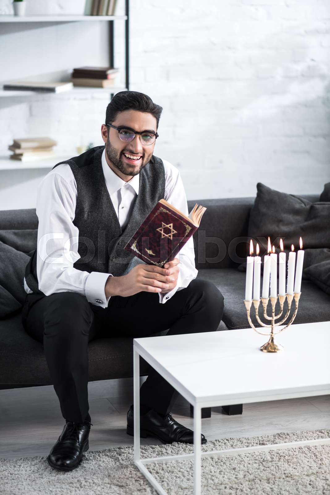handsome and smiling jewish man in glasses holding tanakh | Stock image ...