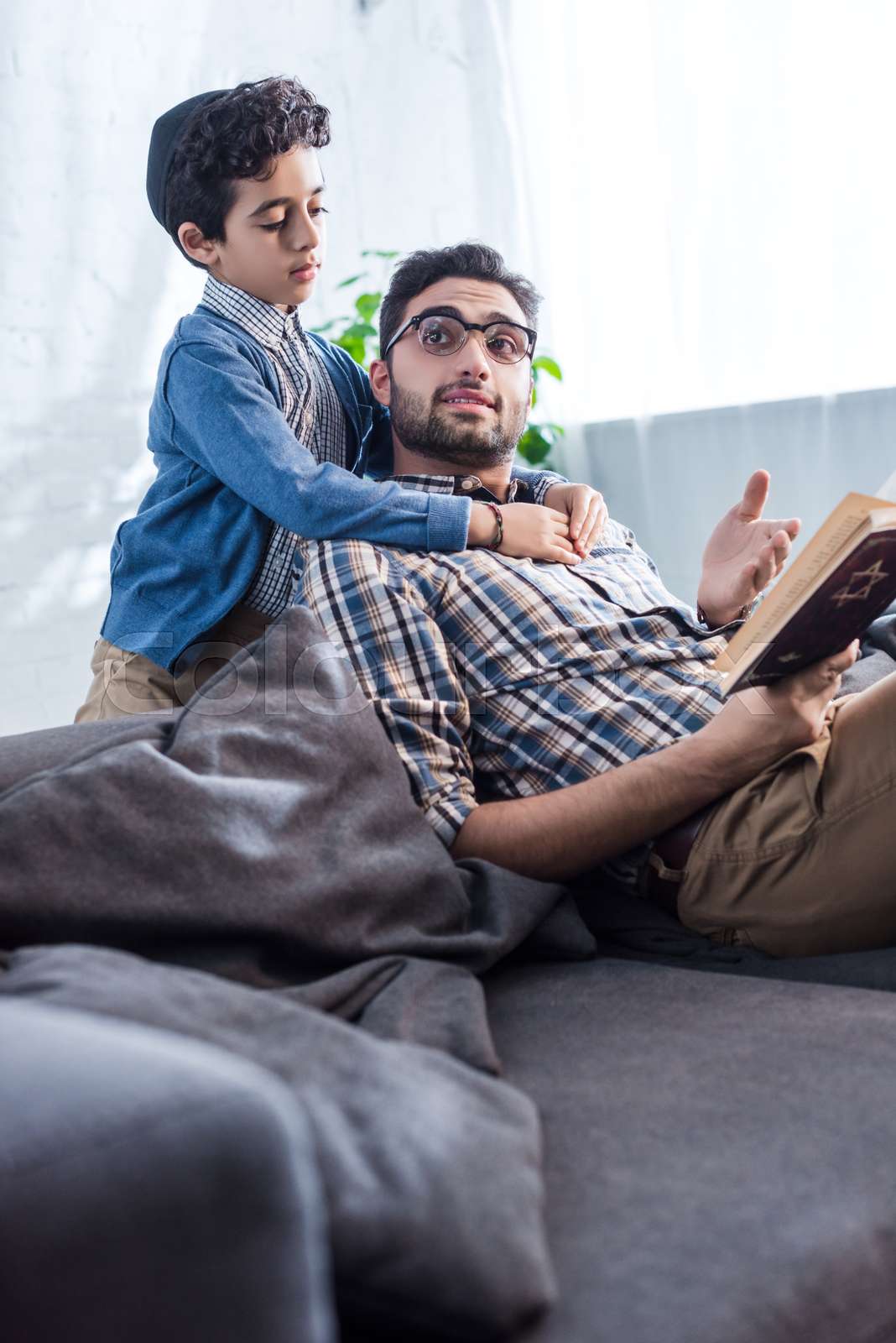 jewish father holding tanakh and talking with son | Stock image | Colourbox