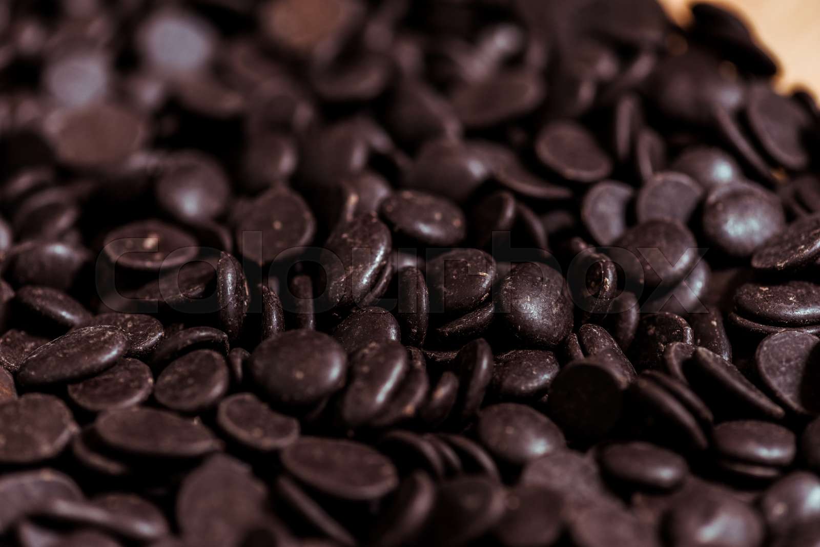 close up of dark and sweet chocolate chips | Stock image | Colourbox