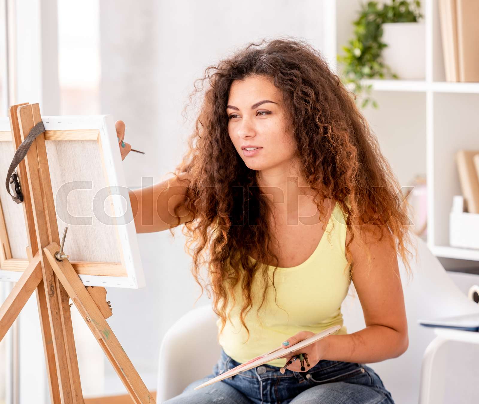 Beautiful girl painting picture | Stock image | Colourbox