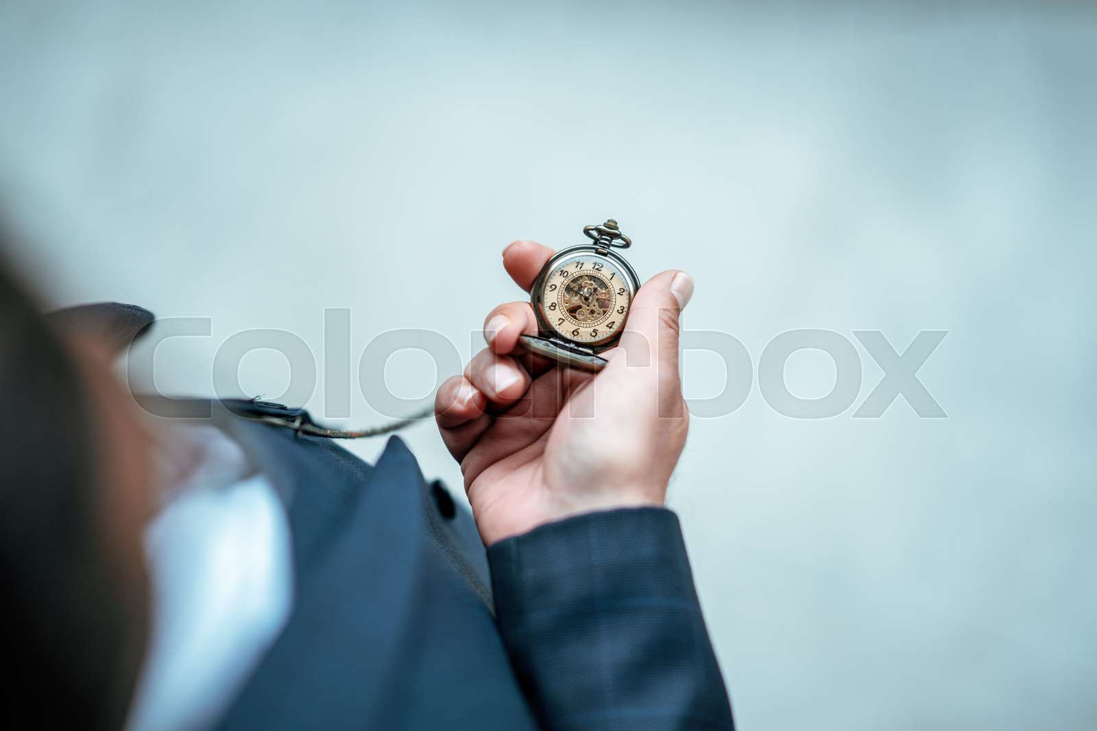 Man is holding and checking his classic pocket watch. Vintage, classic ...