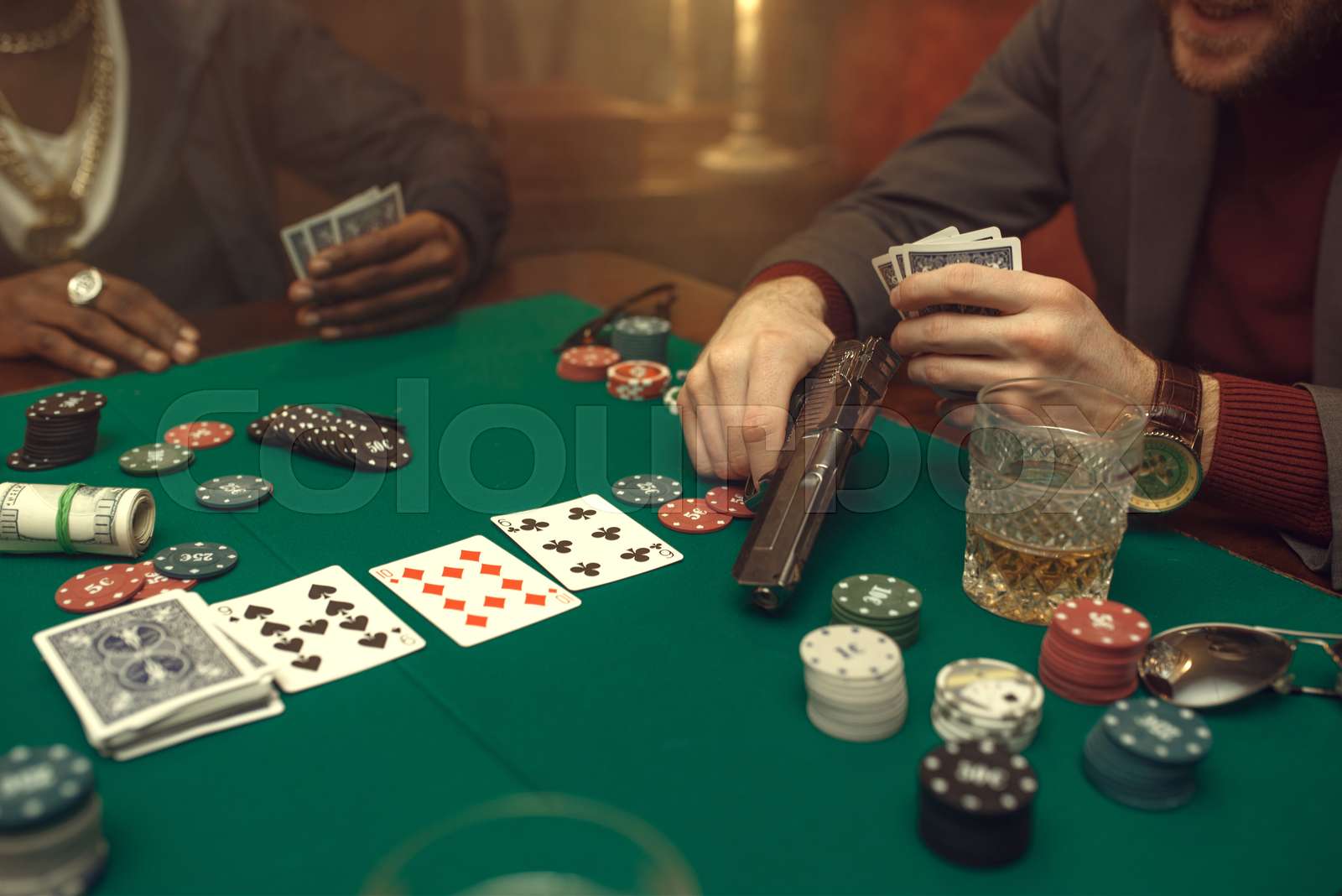 Poker player with gun plays in casino, risk | Stock image | Colourbox