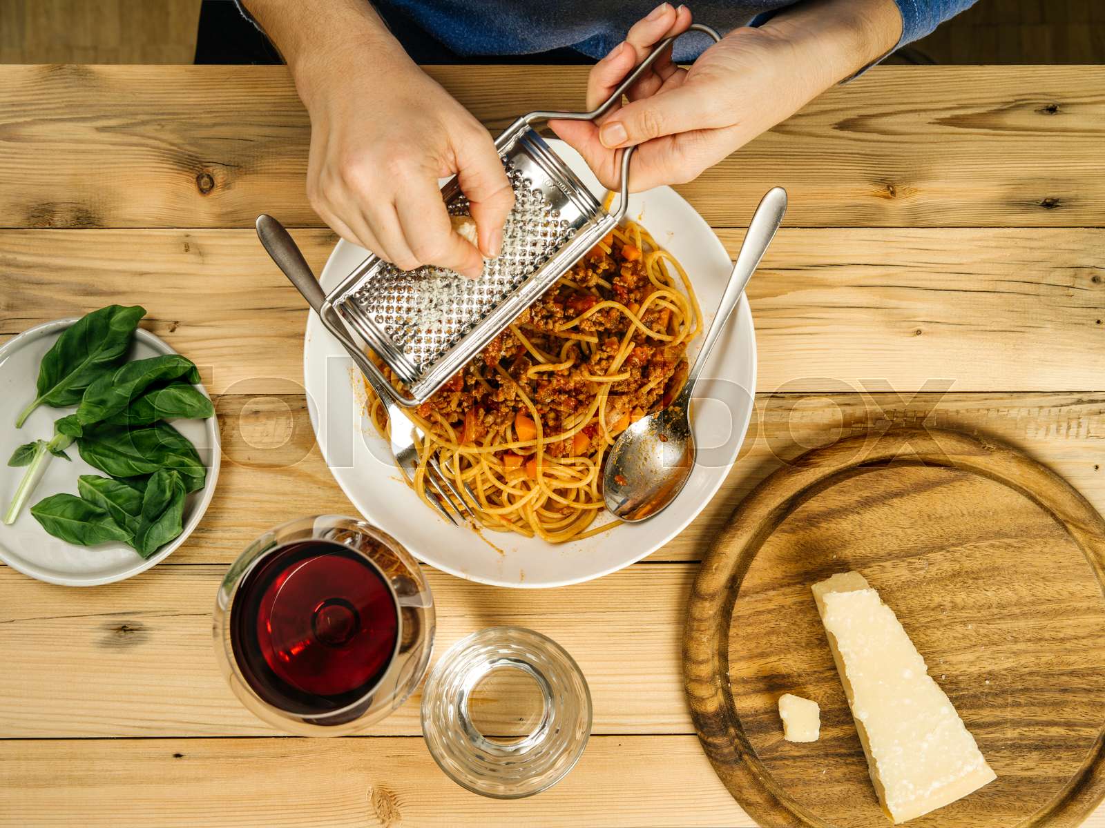 Grating cheese over spaghetti bolognese | Stock image | Colourbox