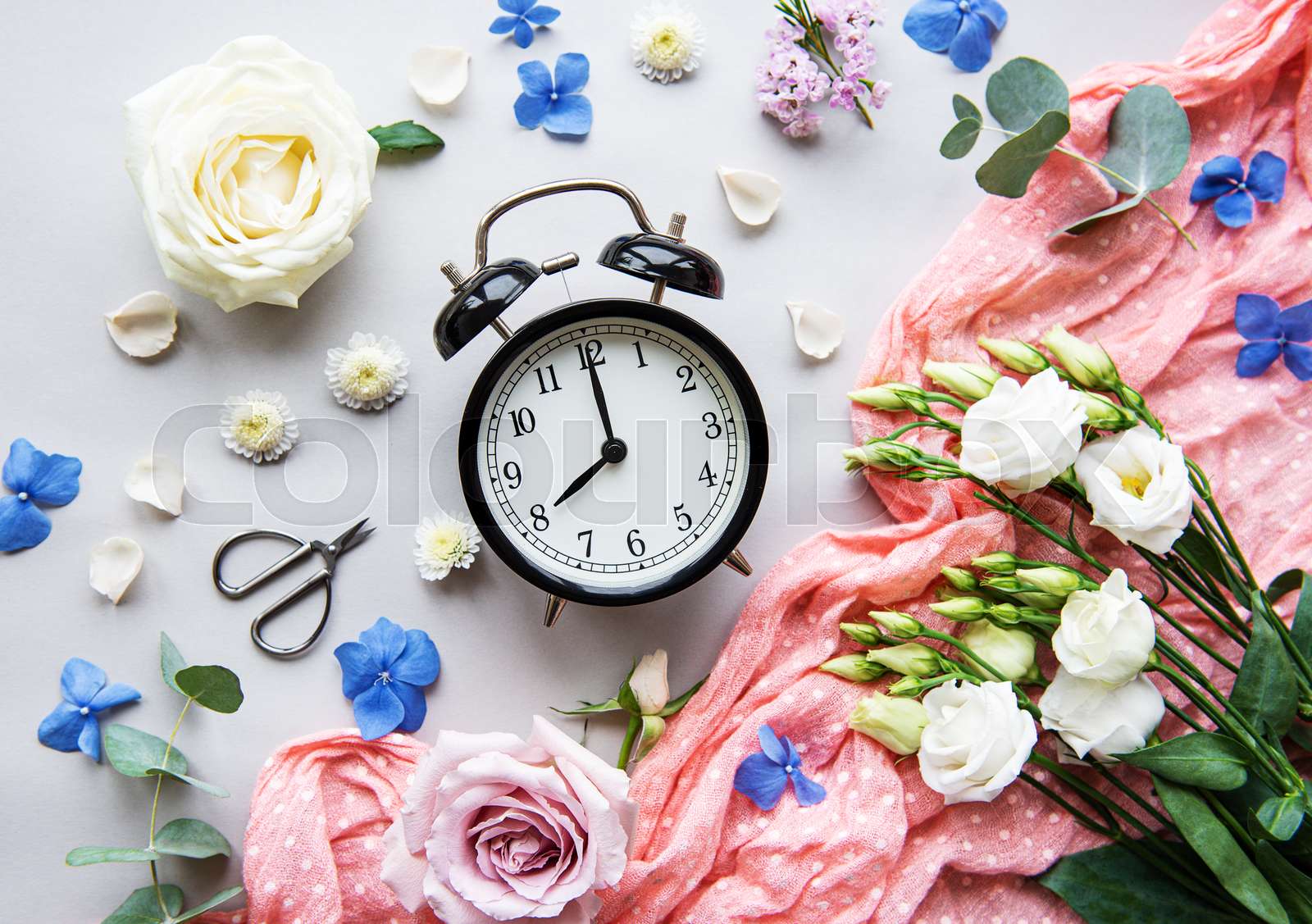 Flower composition and alarm clock | Stock image | Colourbox