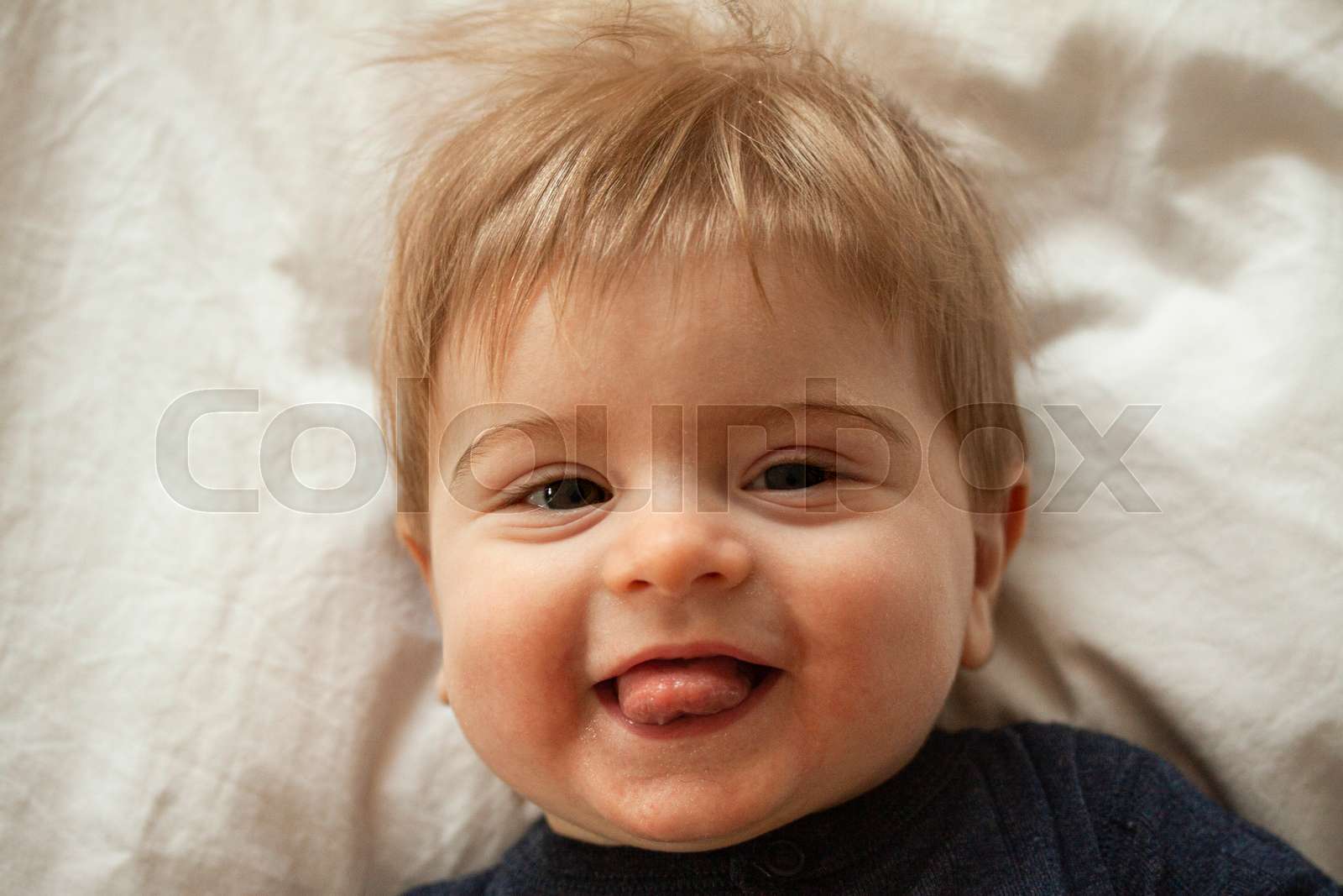 Close up of happy cute baby face with big brown eyes, long eyelashes ...
