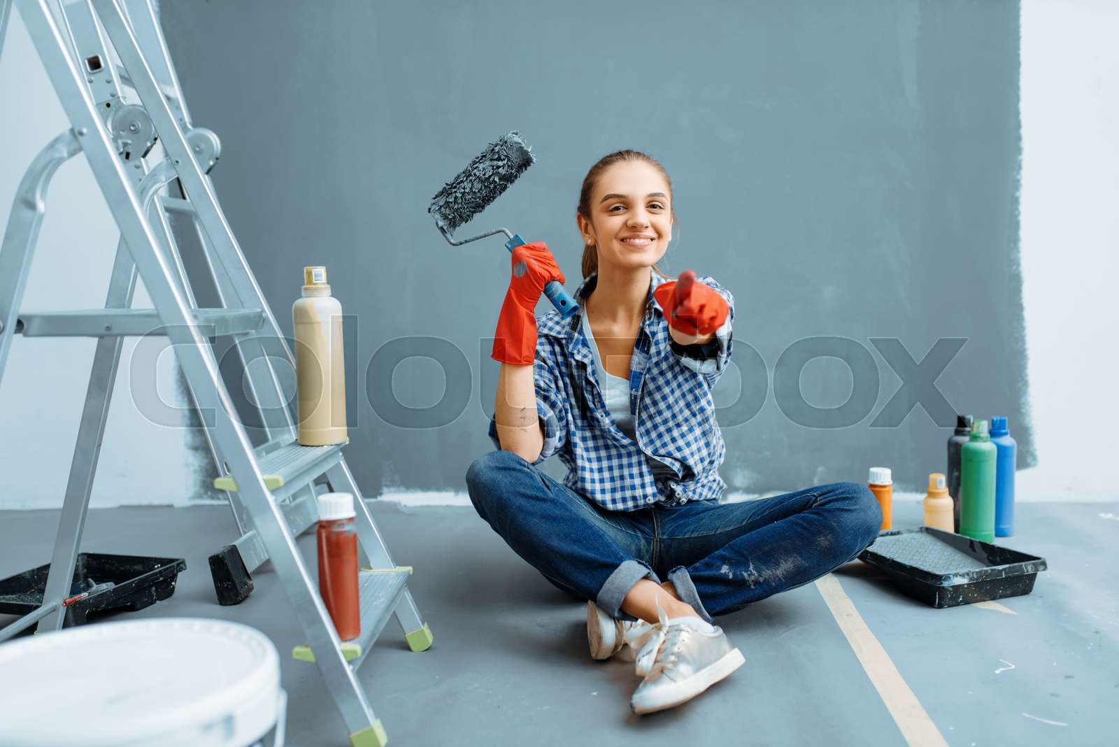 Smiling female house painter after home repair | Stock image | Colourbox