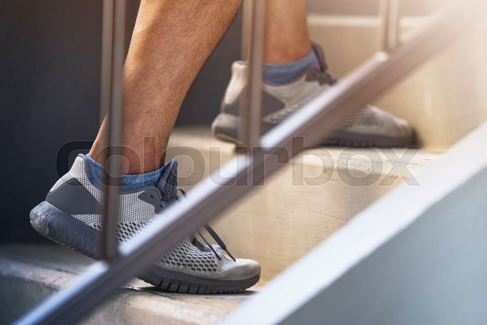 Runner feet running on stairs close up on shoe | Stock image | Colourbox