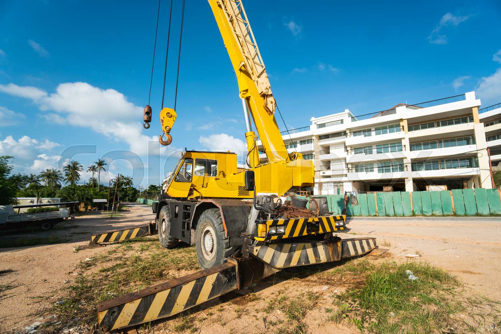 Yellow automobile crane with risen telescopic boom outdoors. Mobile ...