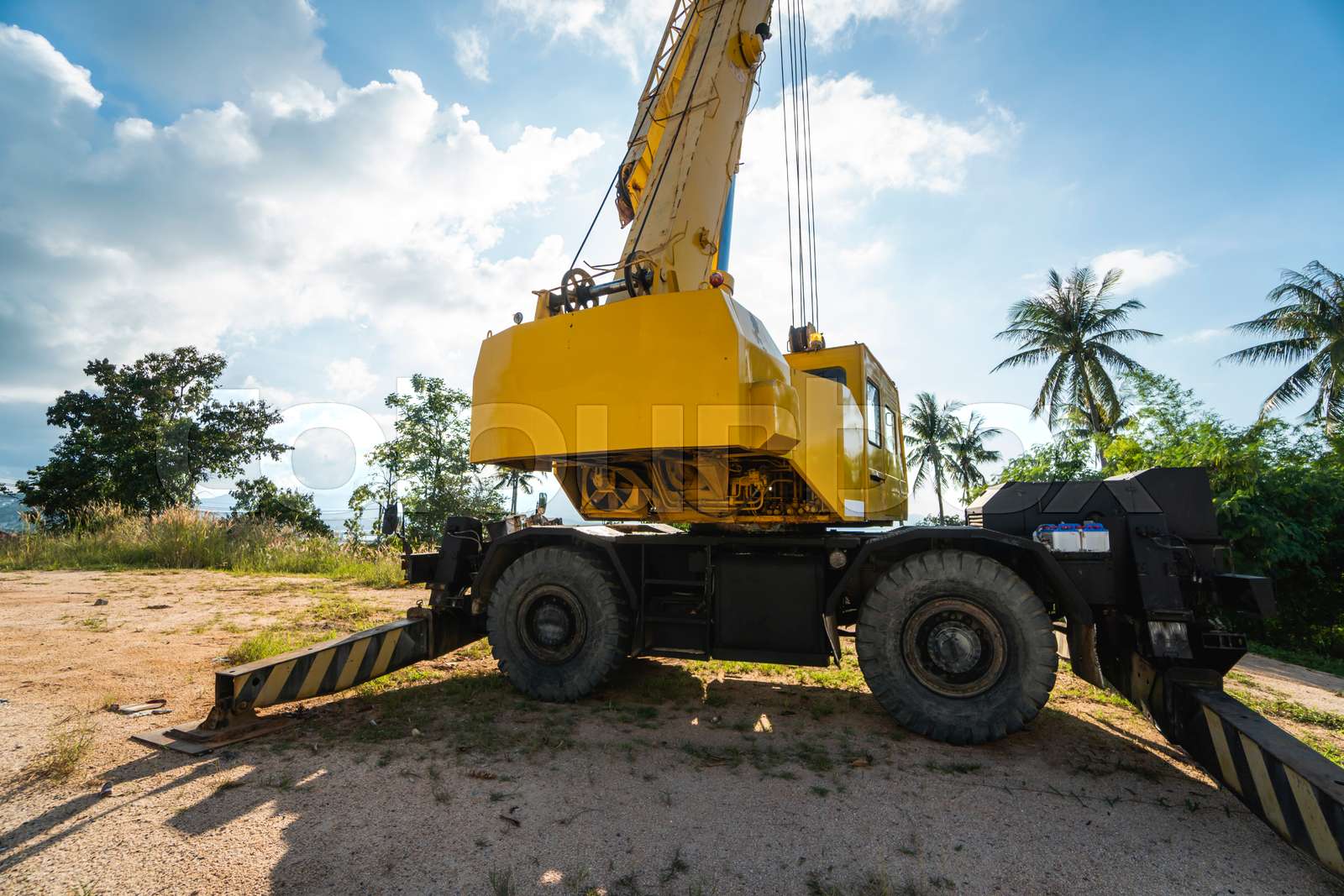 Yellow automobile crane with risen telescopic boom outdoors. Mobile ...