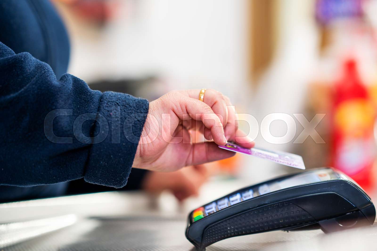 Close up of cashier is using contactless credit card pos terminal to ...