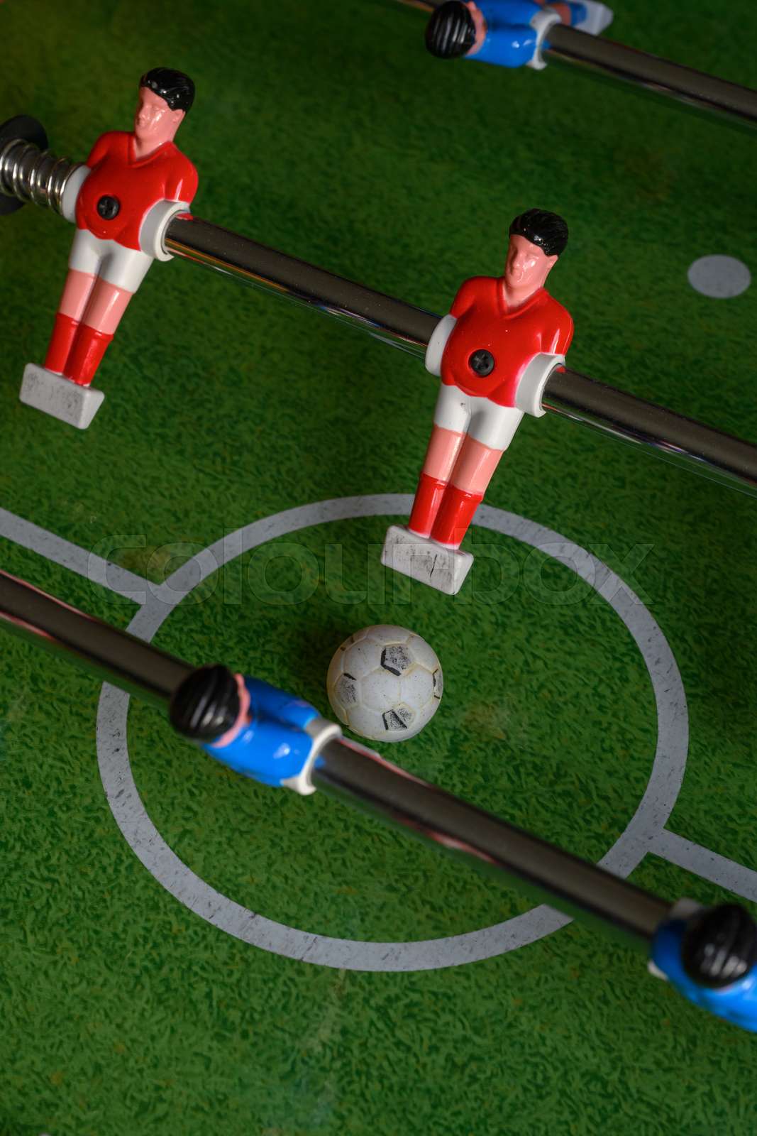 Red and blue football players with the ball | Stock image | Colourbox