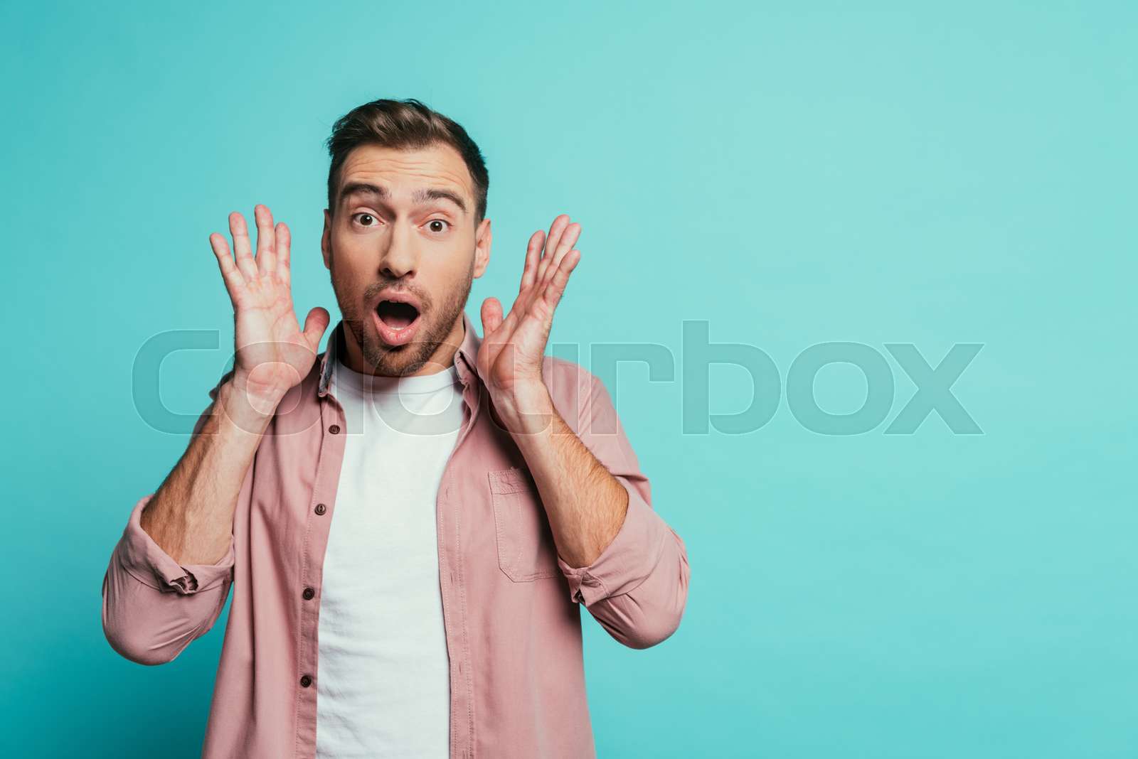shocked handsome man screaming isolated on blue | Stock image | Colourbox