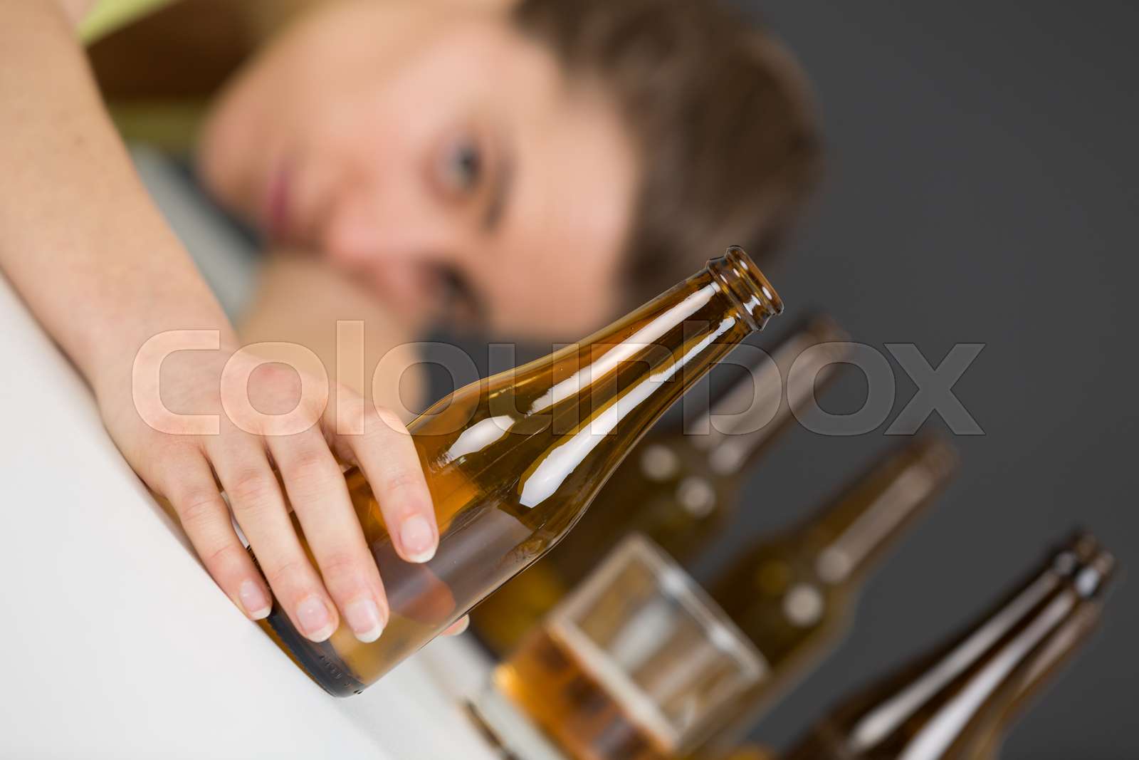drunk woman with bottle in hand | Stock image | Colourbox