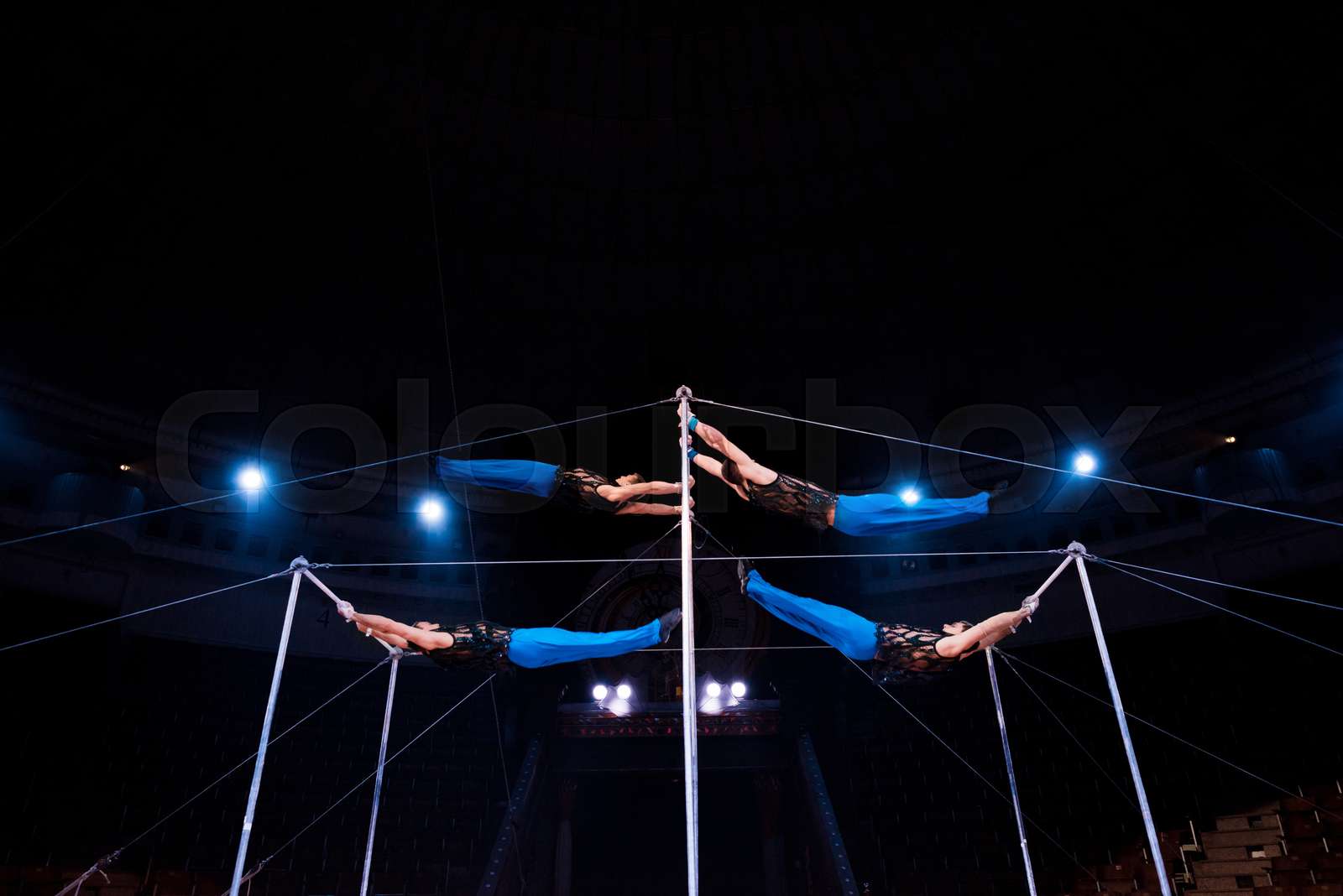 low angle view acrobats performing on horizontal bars in circus | Stock ...