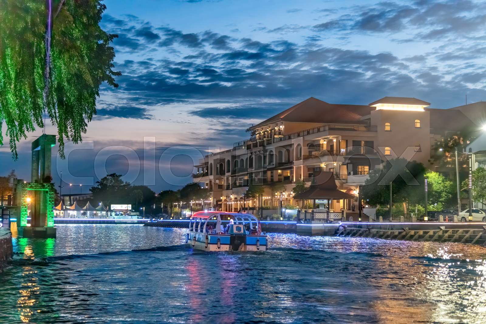 Sunset view of Melaka riverfront from a cruise boat. Malacca River and ...