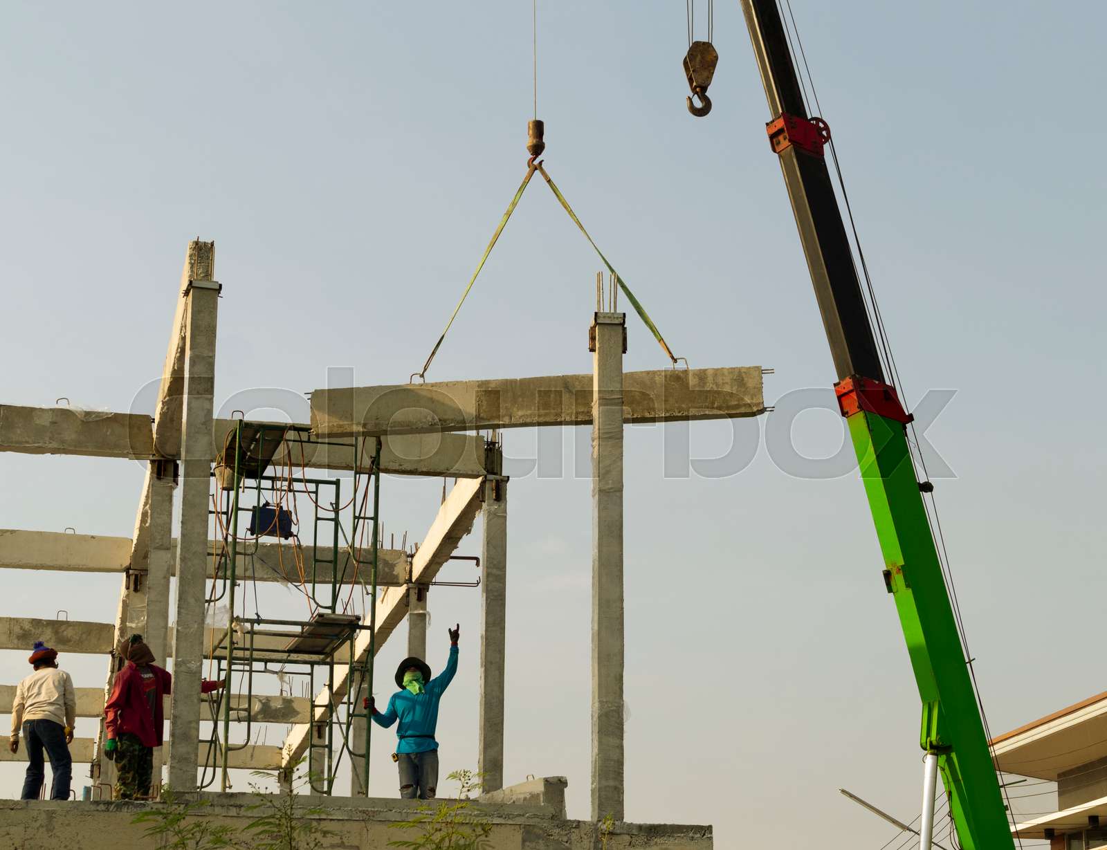 precast concrete beam instralled at construction site by mobile crane ...
