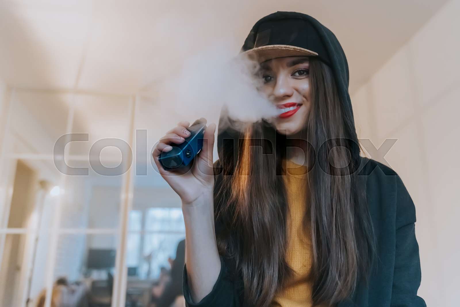 Vaping girl. Young hipster woman vape e-cig at the vapeshop. Hip-hop ...