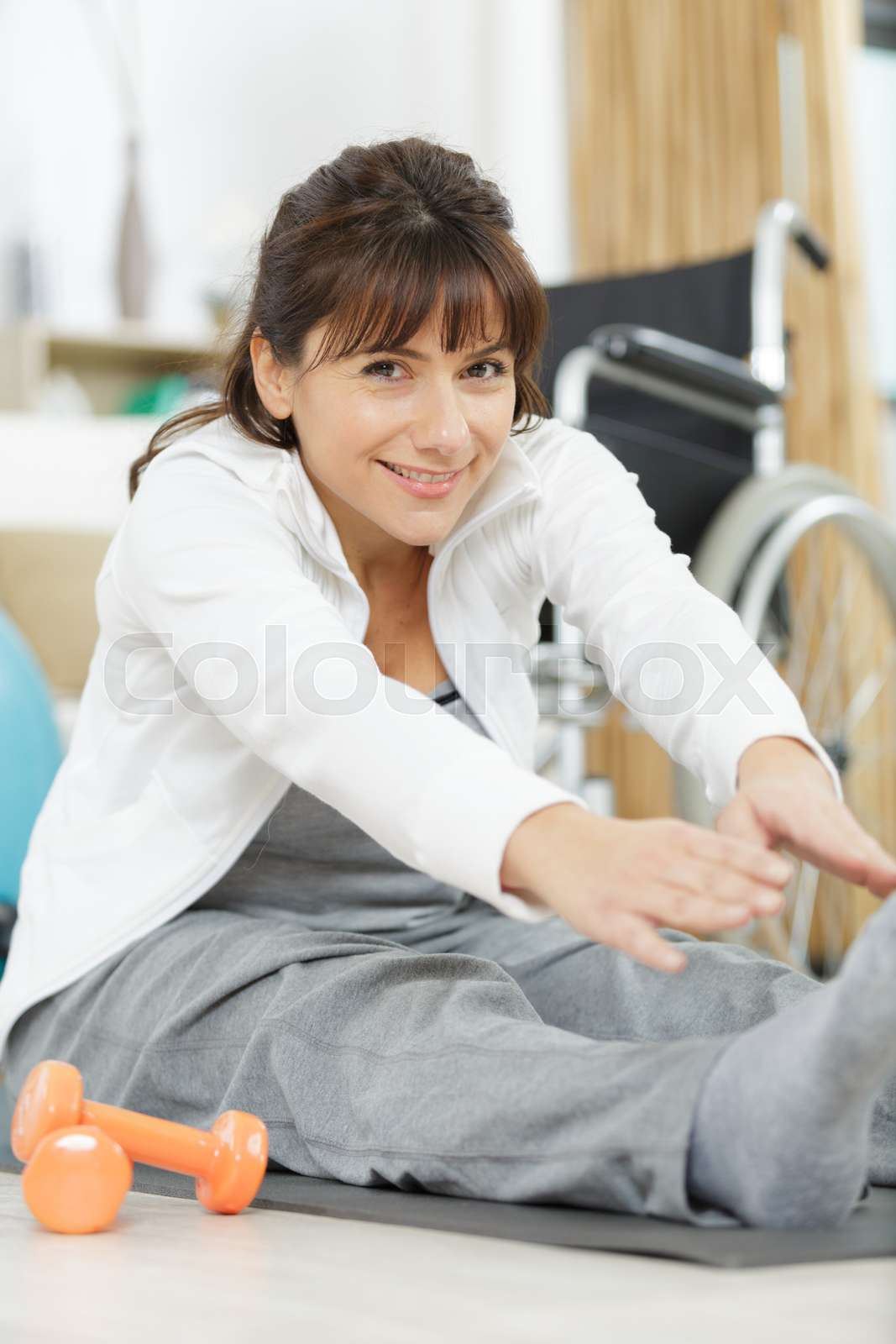woman with paralyzed legs doing rehabilitation | Stock image | Colourbox