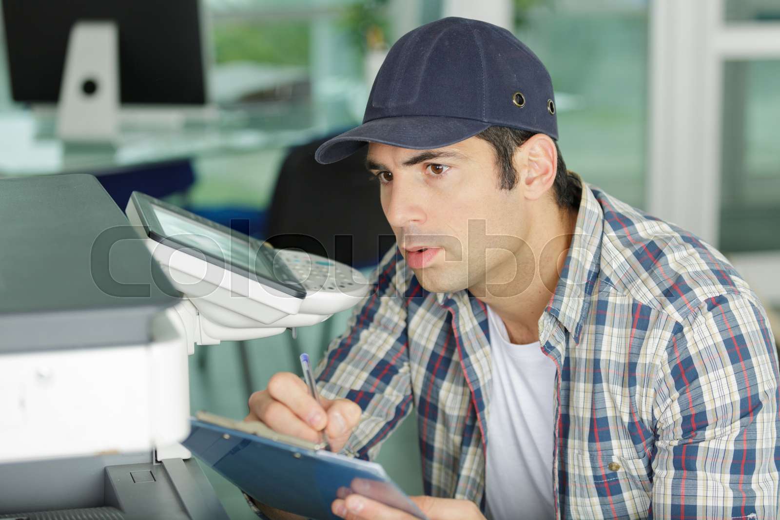 man checking the quality of a printer | Stock image | Colourbox
