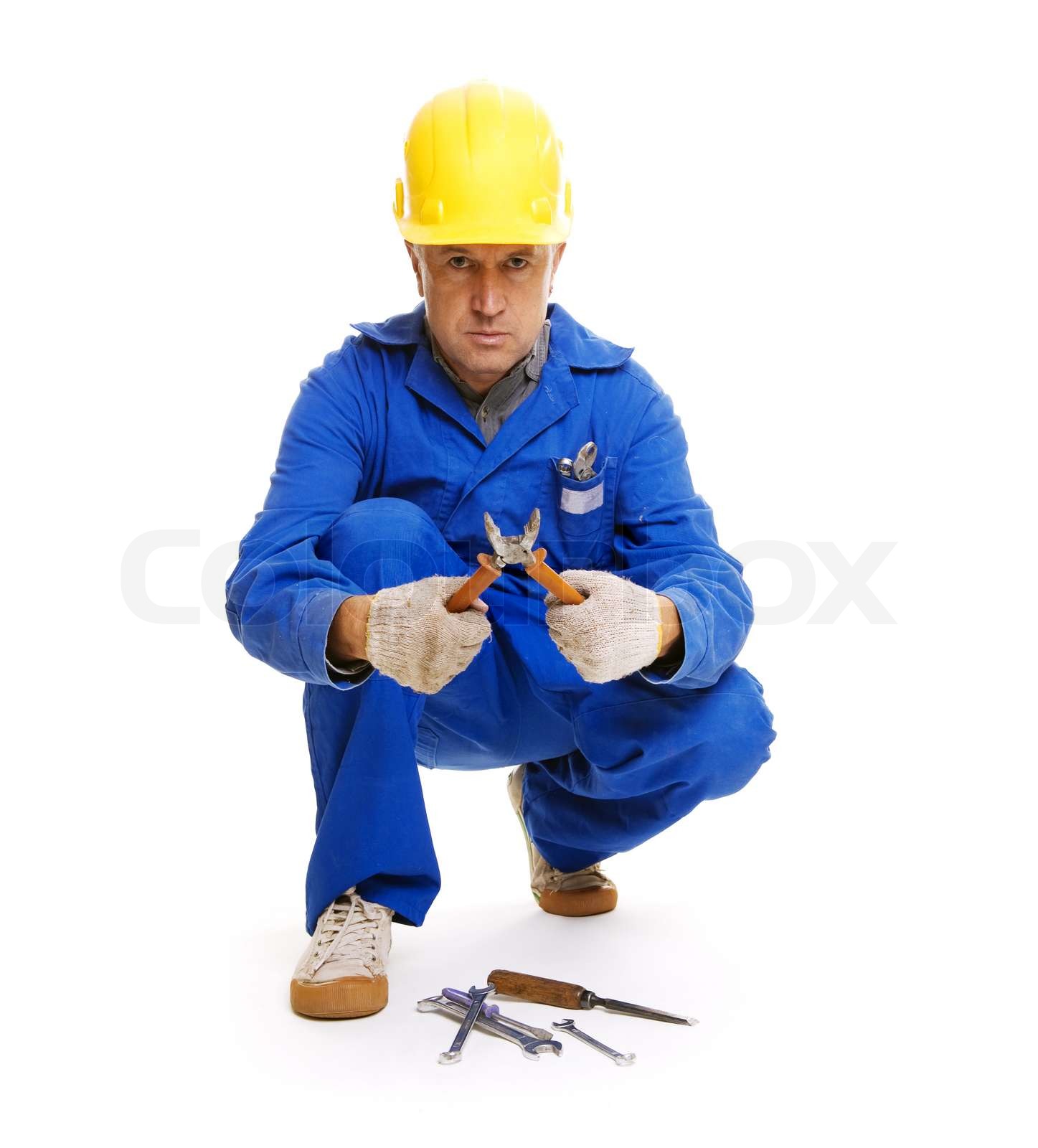 handsome workman sitting on the floor with different tools | Stock ...