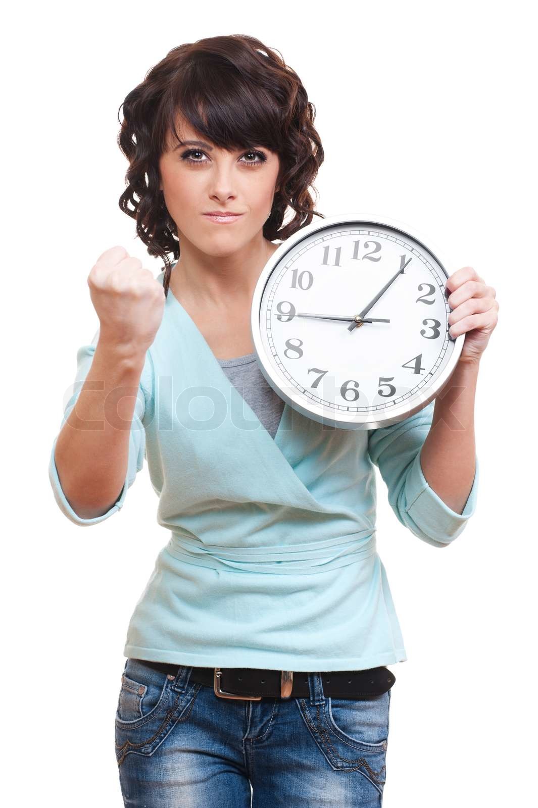 strict young woman holding clock | Stock image | Colourbox