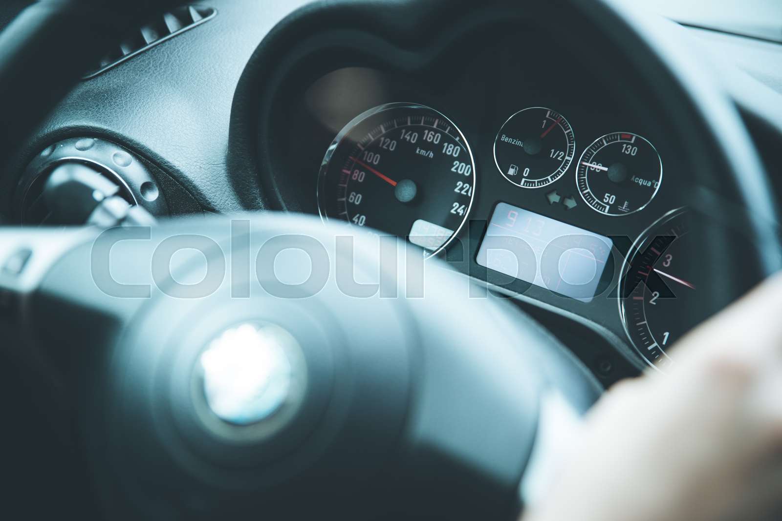 Sports car dashboard and steering wheel with tachometer and fuel ...