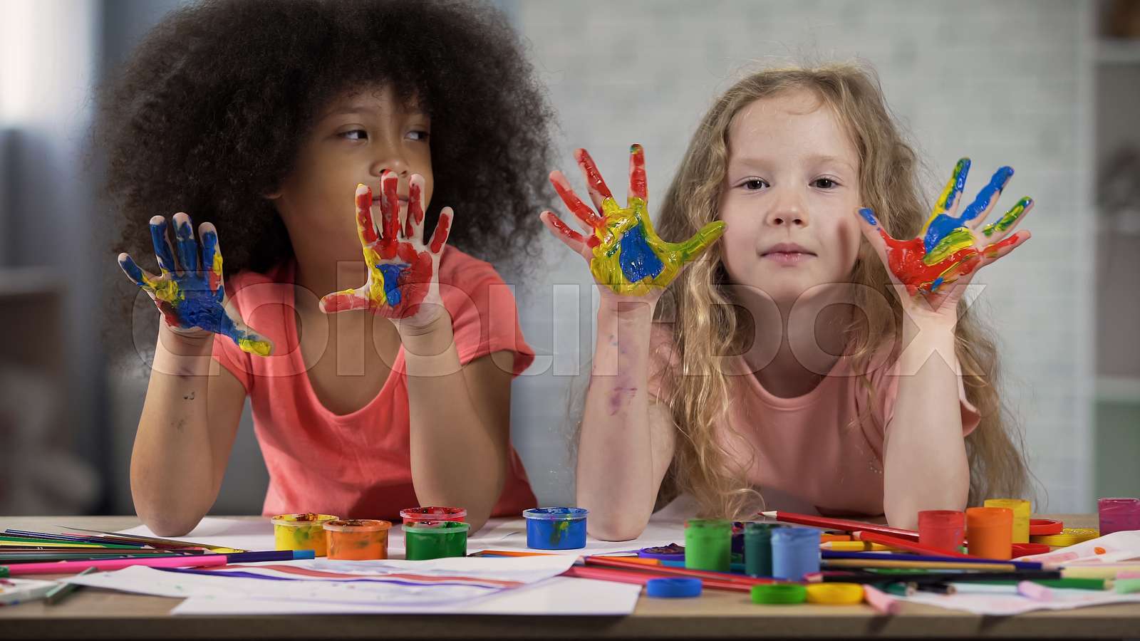 Multiracial kids visiting art lesson at club, palms in paints, happy ...