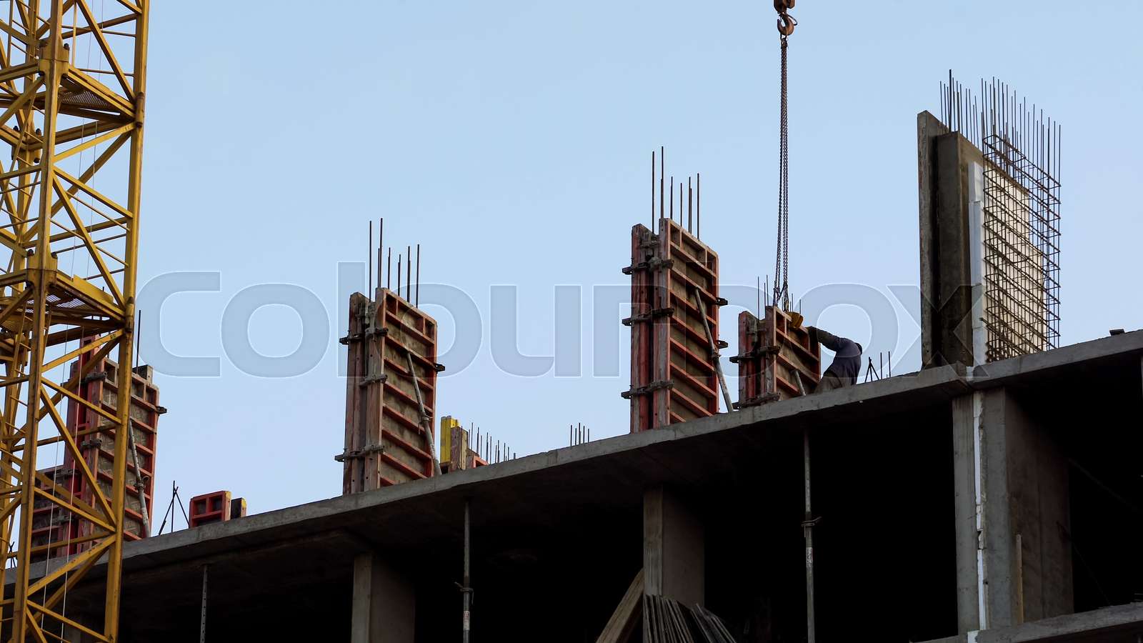 Building site shot workers installing concrete walls housing ...