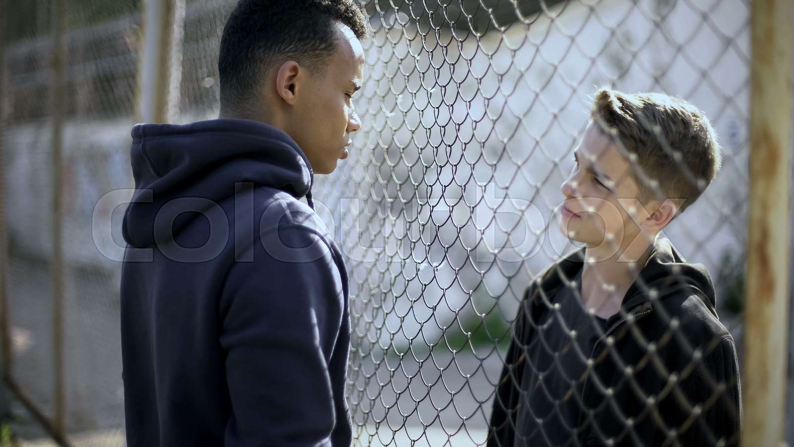 Rich and poor separated by fence, two boys of different nationalities ...