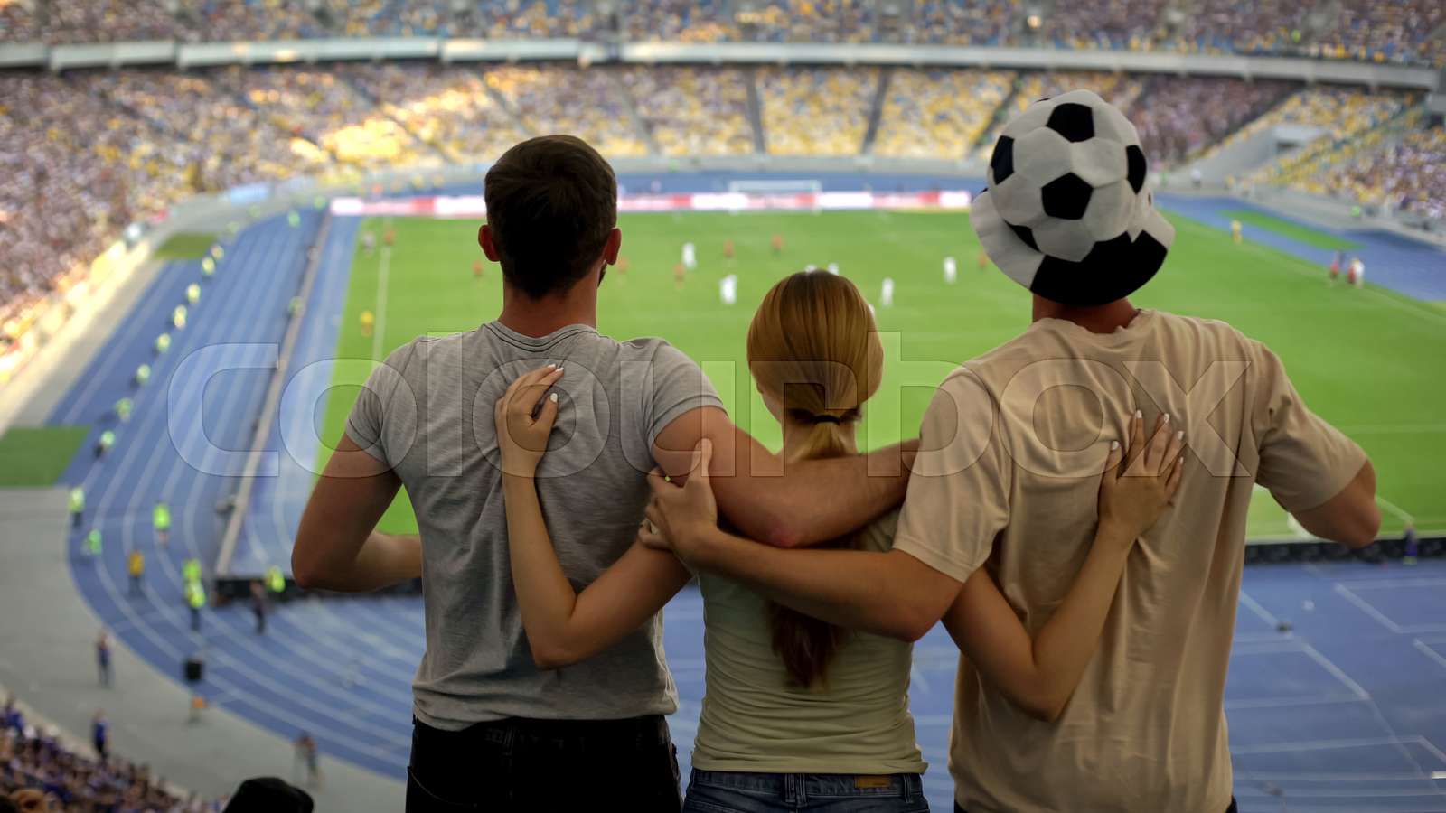Football fans hugging at stadium, friends cheering victory of favorite ...
