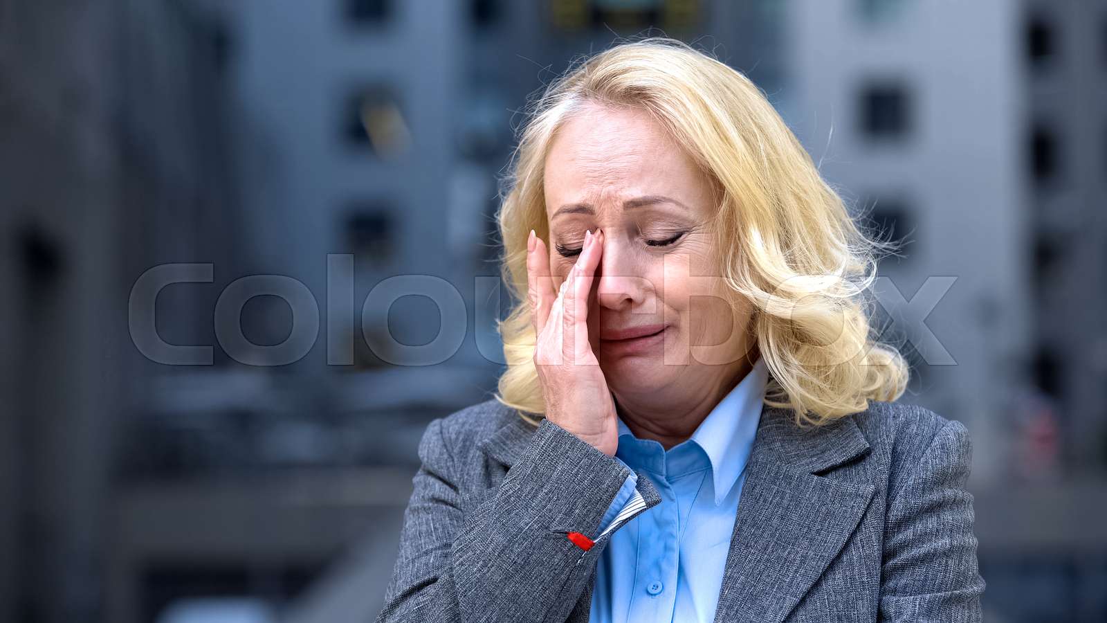 Sad crying female employee in formal suit, pension age unemployment ...
